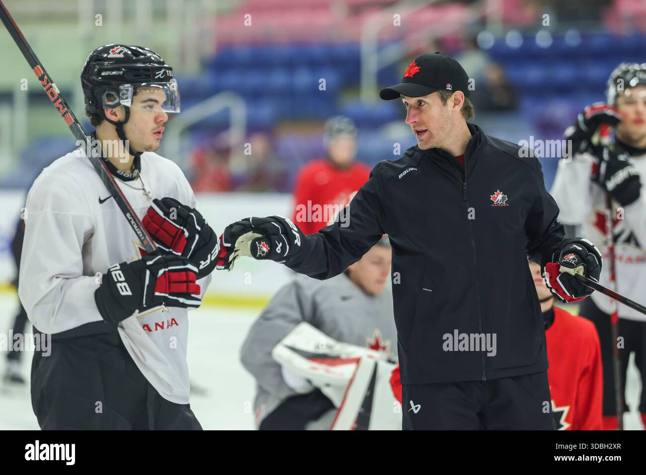 Tij Iginla, left, of Lake Country, British Columbia, talks with coach ...