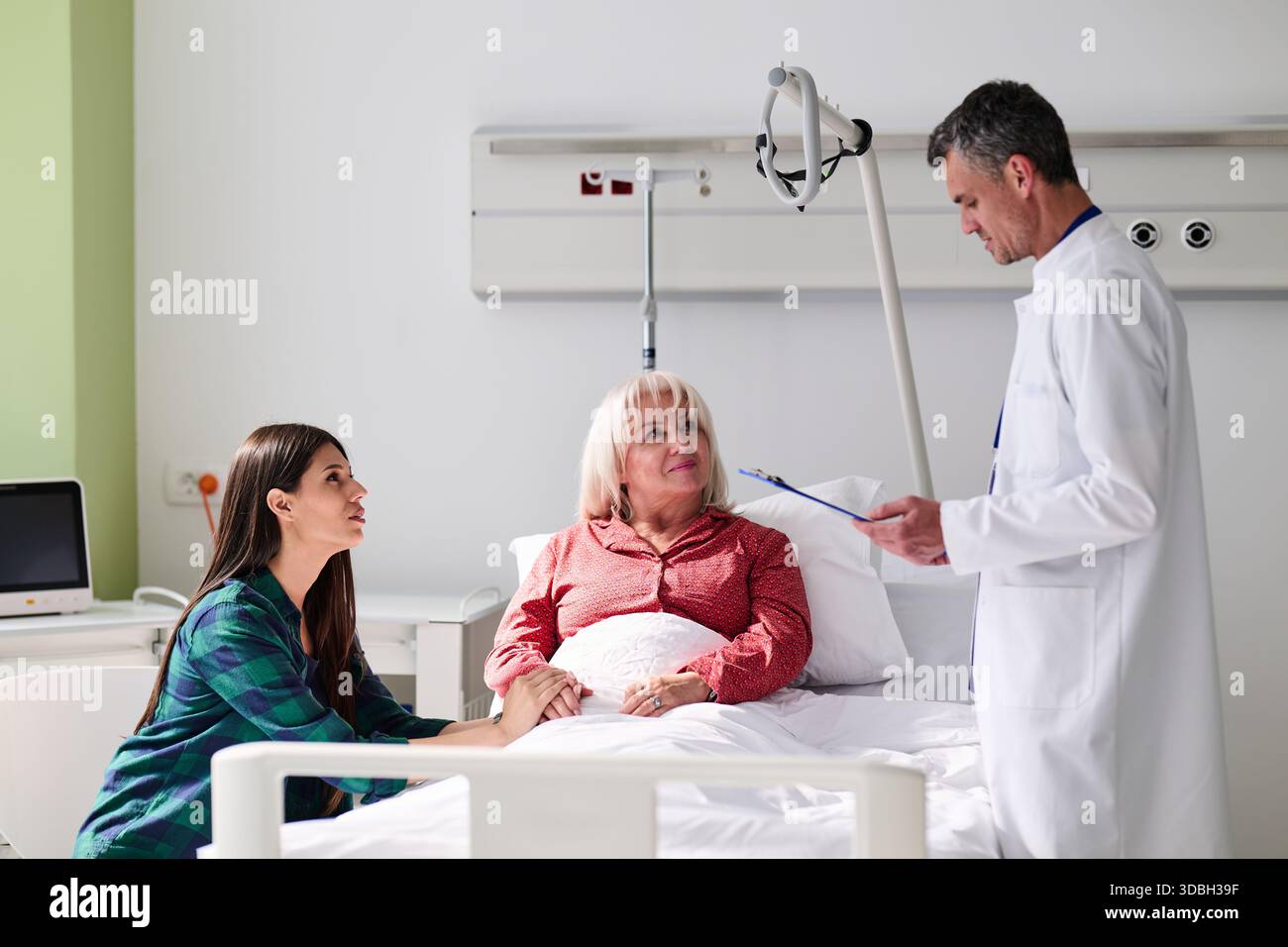 Healthcare professionals interact with patients and family members in a ...
