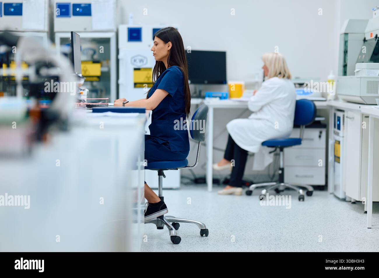 Laboratory workers conducting research in a modern science facility ...