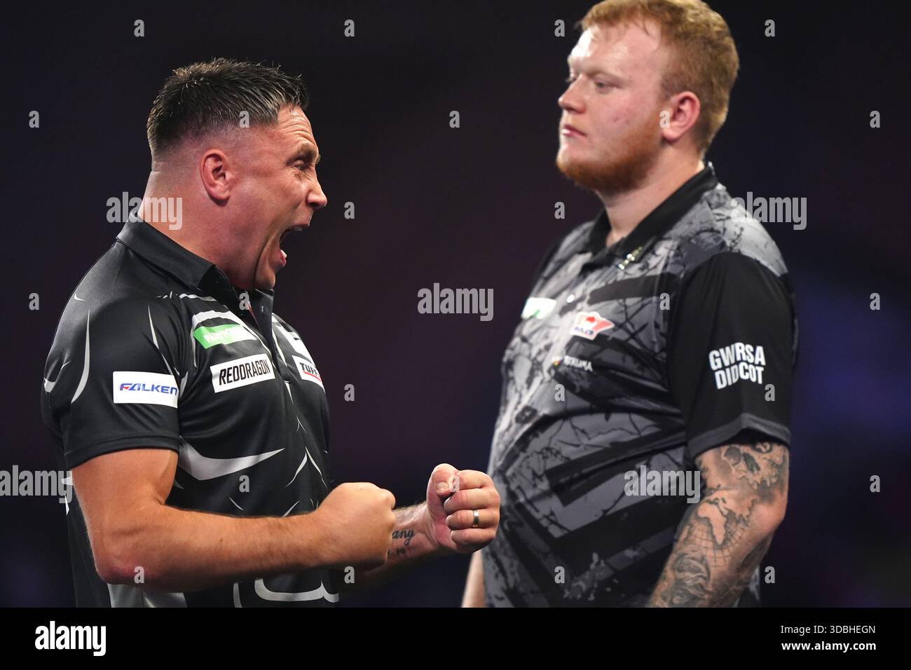 Gerwyn Price (left) celebrates winning the second set against Adam ...
