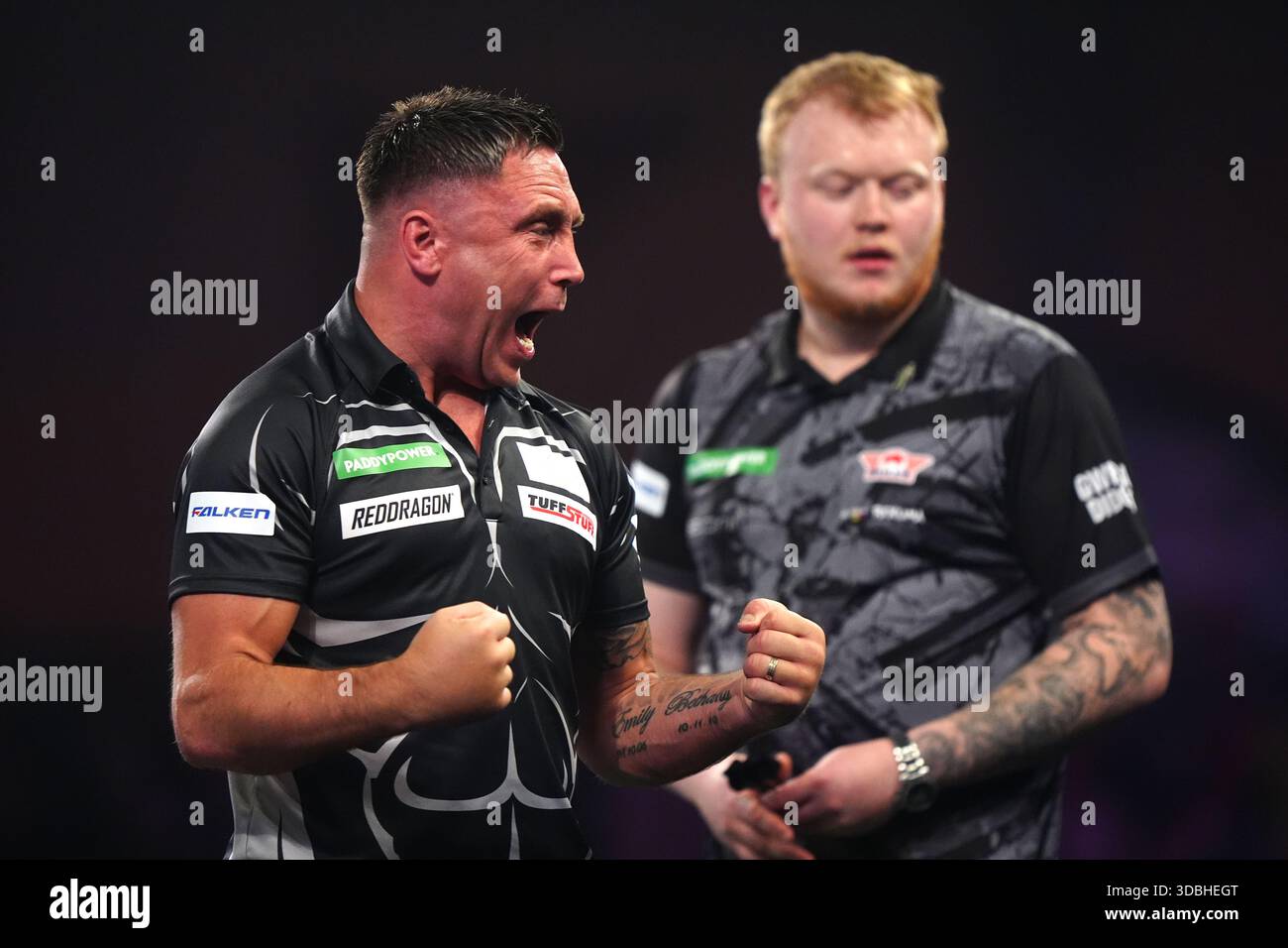 Gerwyn Price (left) celebrates winning the second set against Adam ...