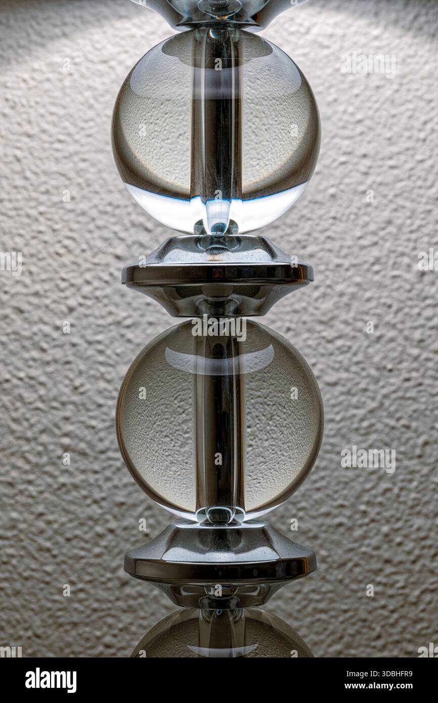 The detail of glass globes on the column and pipe of a decorative table ...