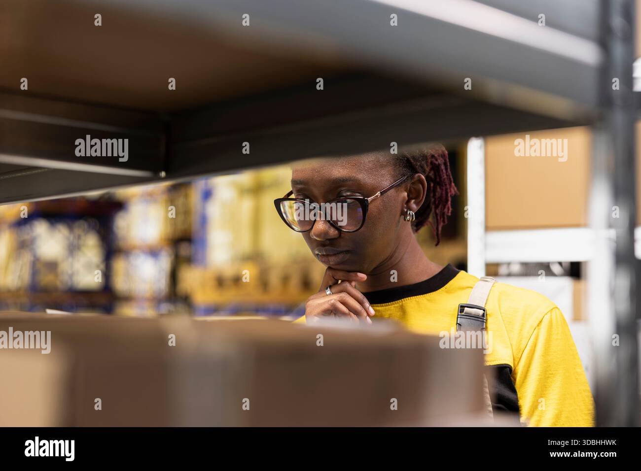 Warehouse clerk ensuring all packages have tracking numbers tags for ...