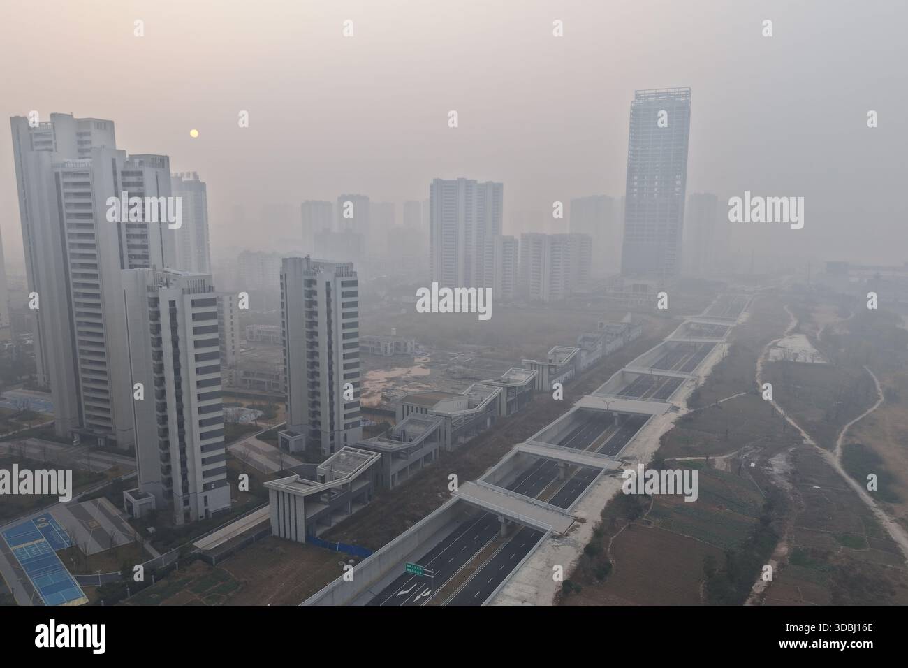 Buildings are faintly visible in the haze in Fuyang City, Anhui ...