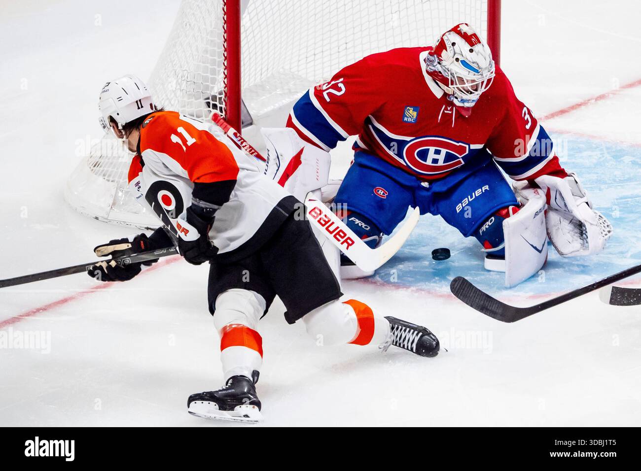 Montreal Canadiens goaltender Jacob Fowler (32) makes a save on ...