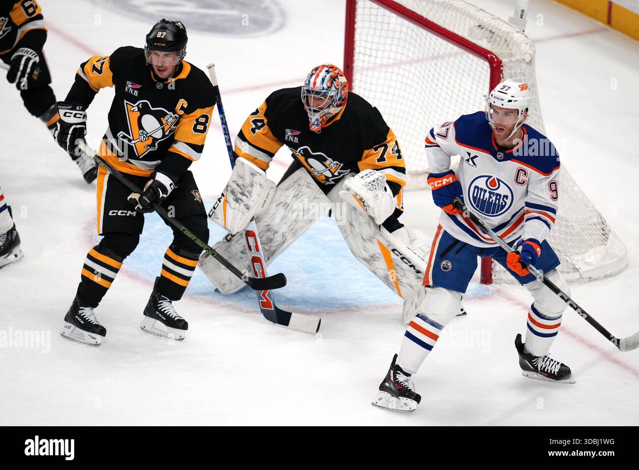 Pittsburgh Penguins' Sidney Crosby (87) defends against Edmonton Oilers' Connor McDavid (97) in ...