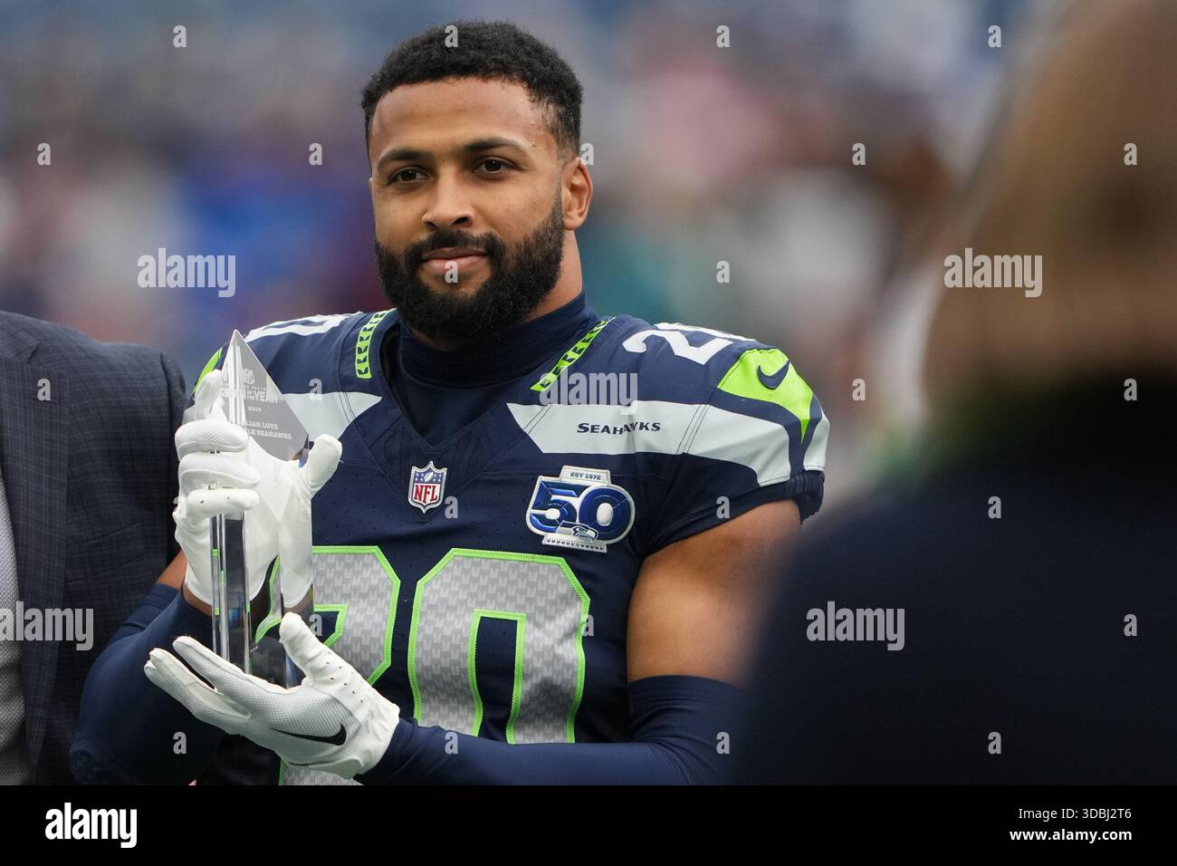 Seattle Seahawks safety Julian Love (20) receives a trophy for being ...