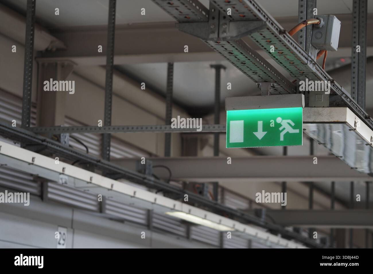 Emergency exit sign in a modern building near a corridor Stock Photo ...