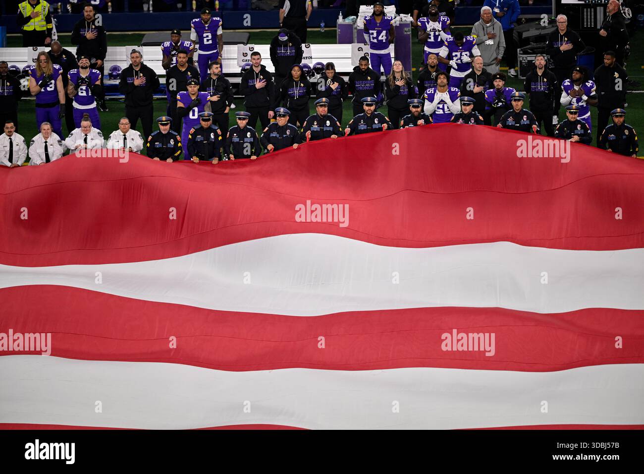 First responders hold a large United States flag during the national ...