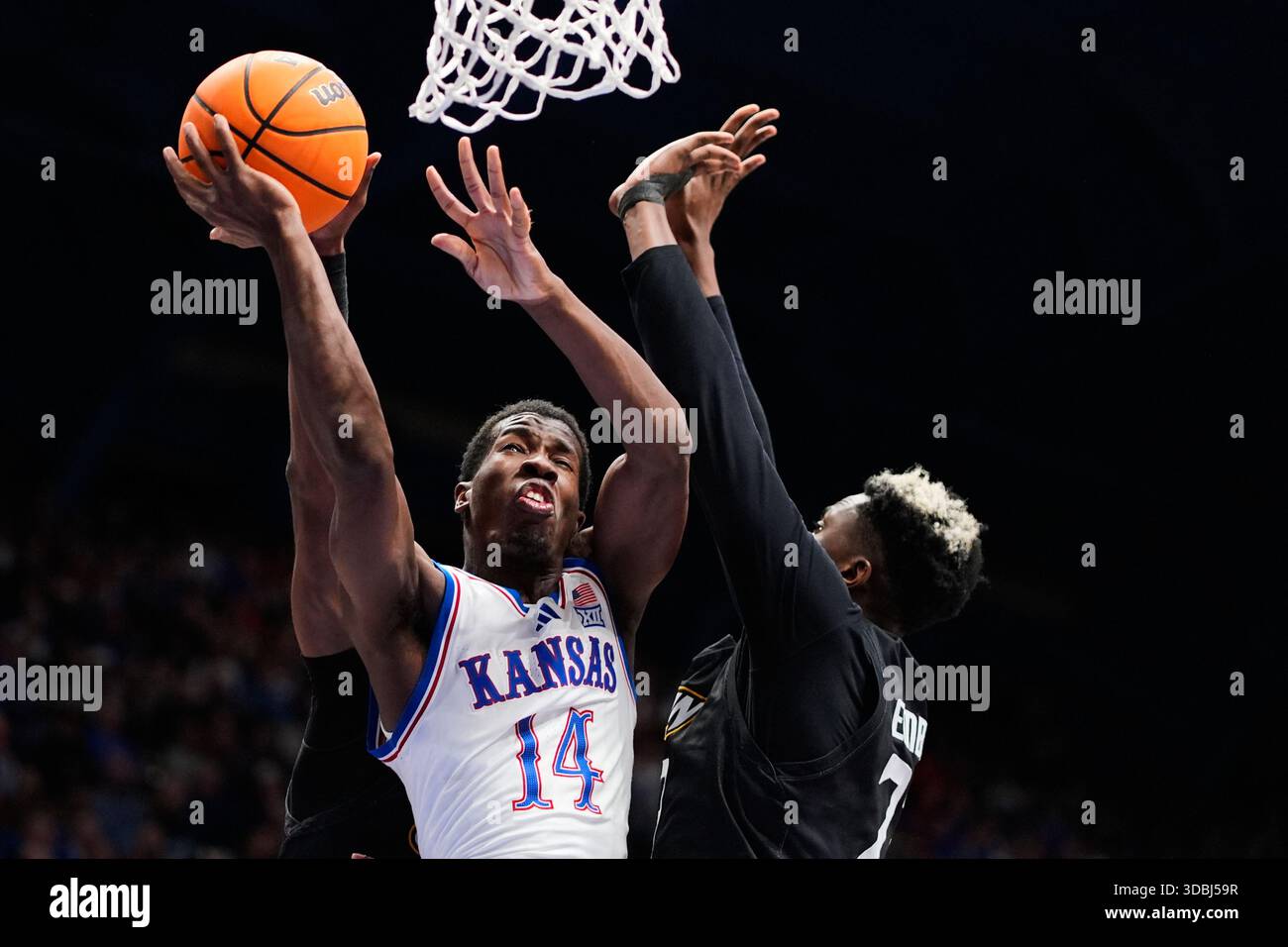 Kansas guard Melvin Council Jr. (14) attempts to shoot under pressure ...