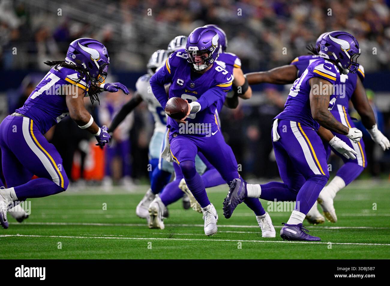 Minnesota Vikings quarterback J.J. McCarthy (9) hands the ball off to ...