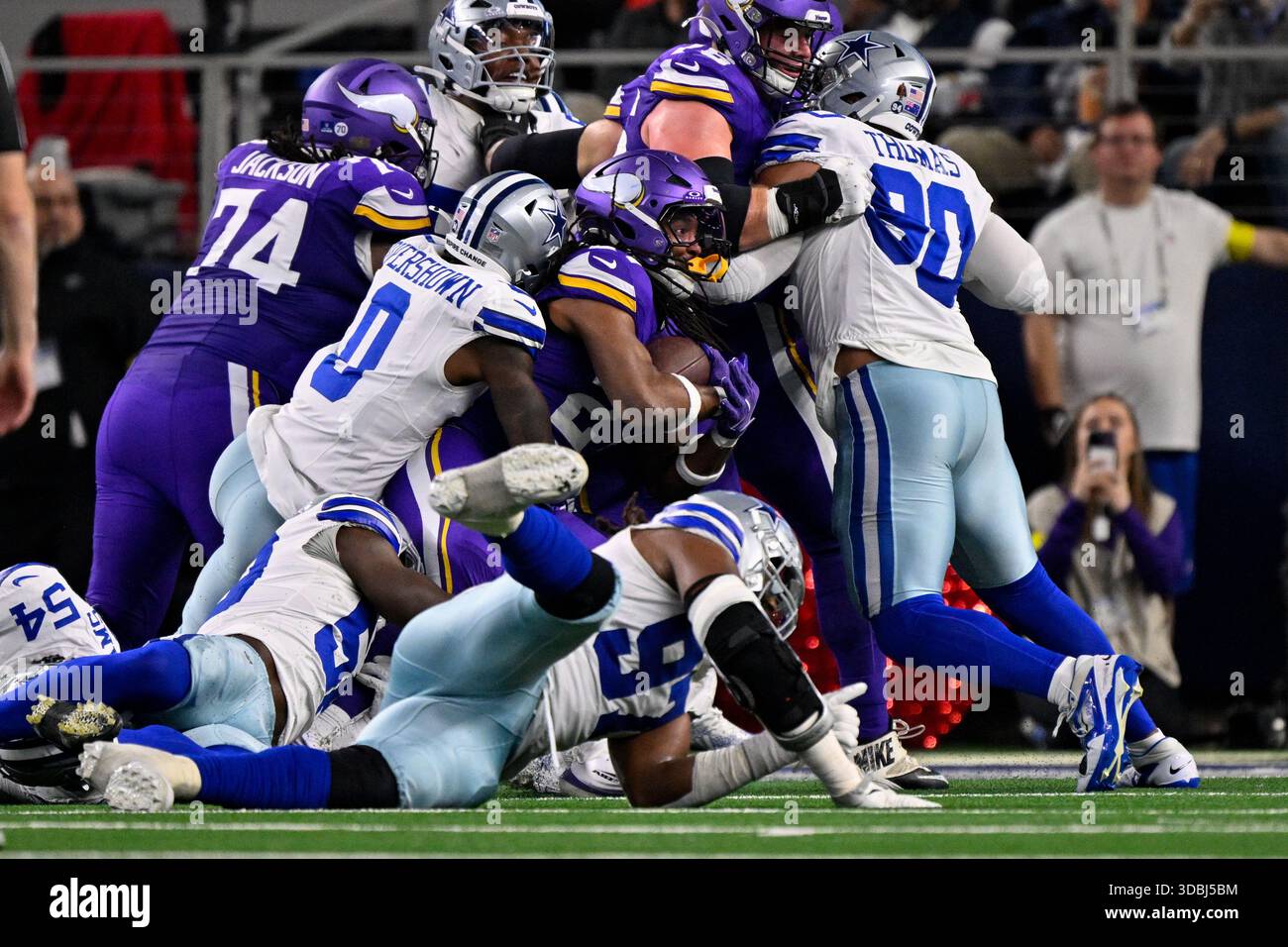 Minnesota Vikings running back Jordan Mason (27) is tackled by Dallas ...