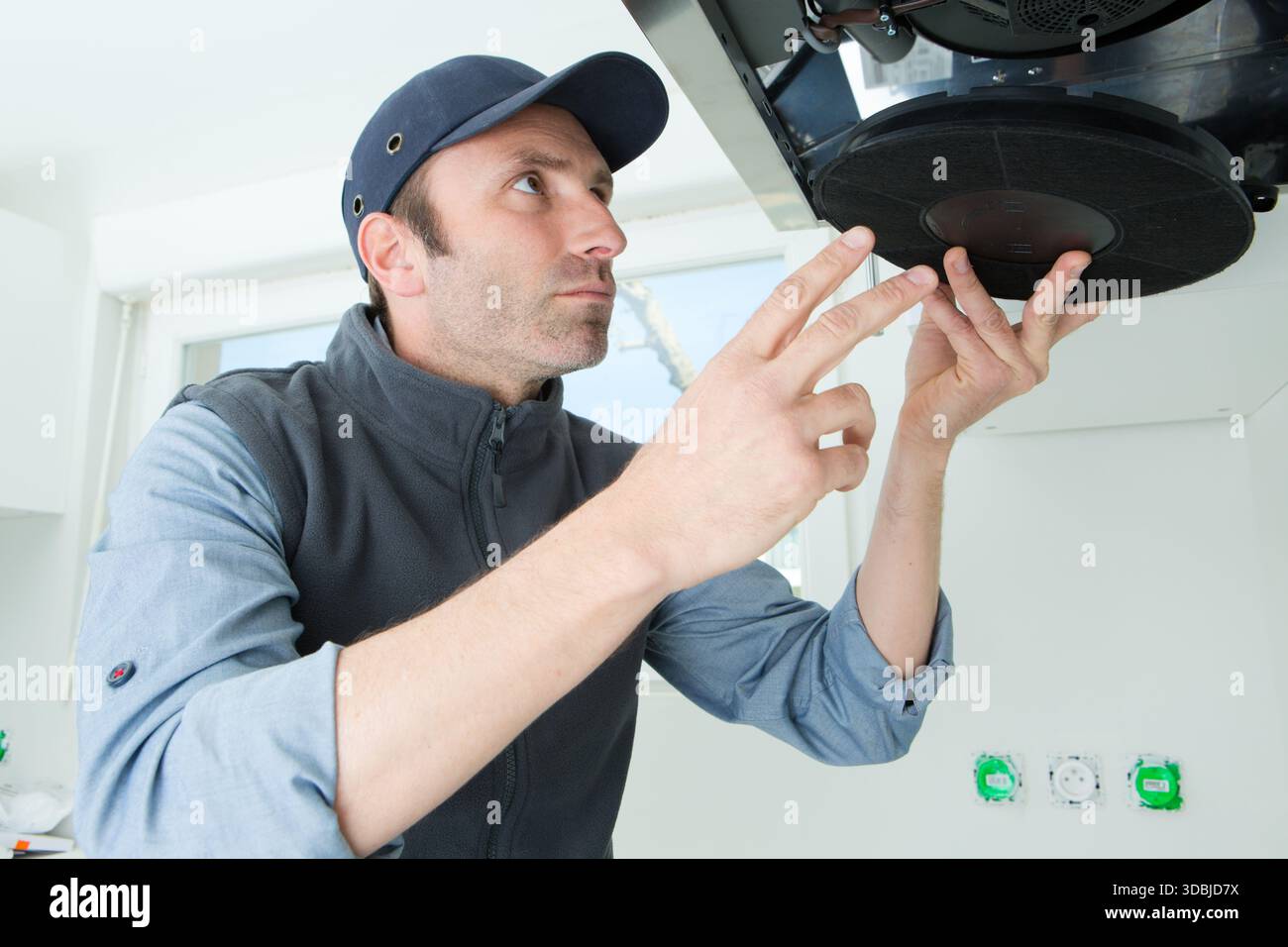 technician inspection kitchen exhaust fan problem Stock Photo - Alamy