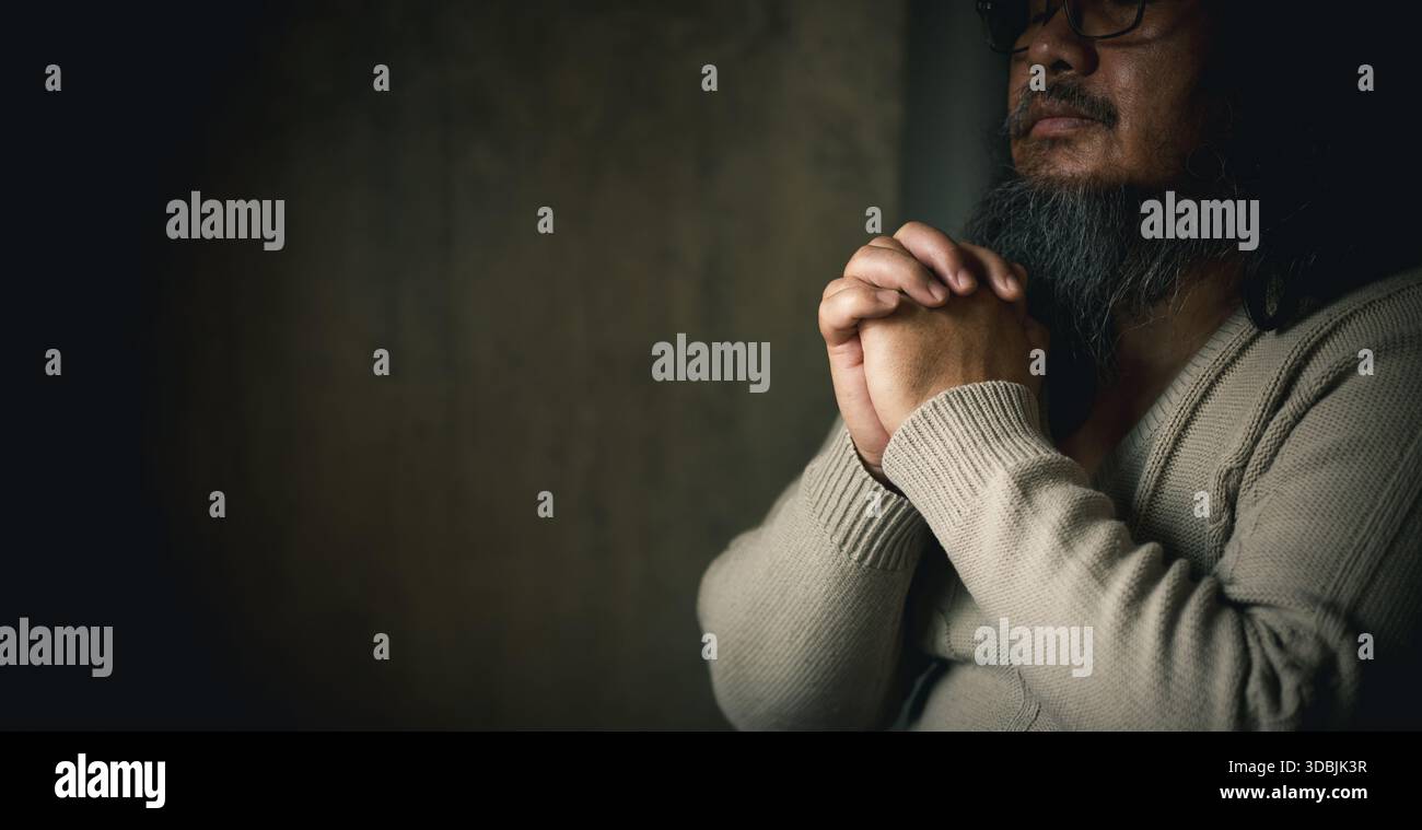 Man hand in prayer, expressing his religious faith in God through ...