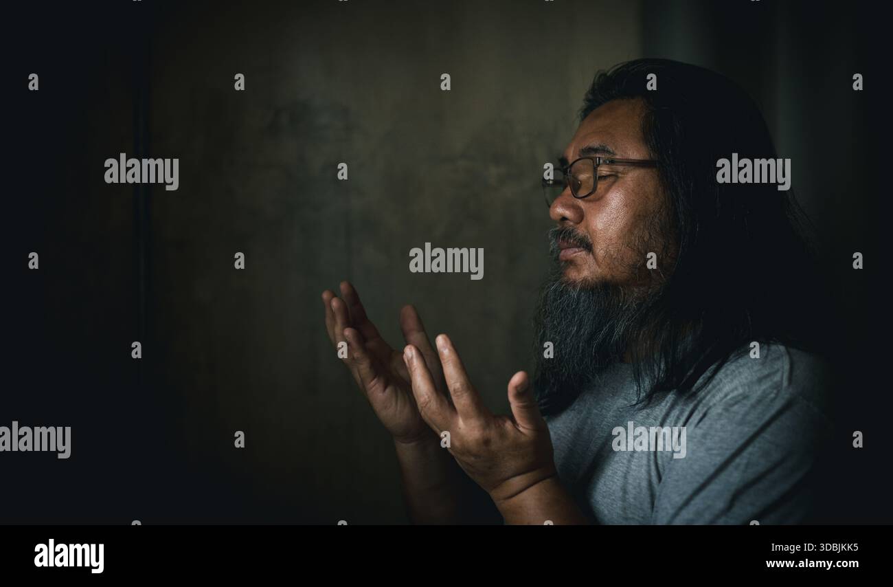 Person man, turned to God in prayer, demonstrating their religious ...