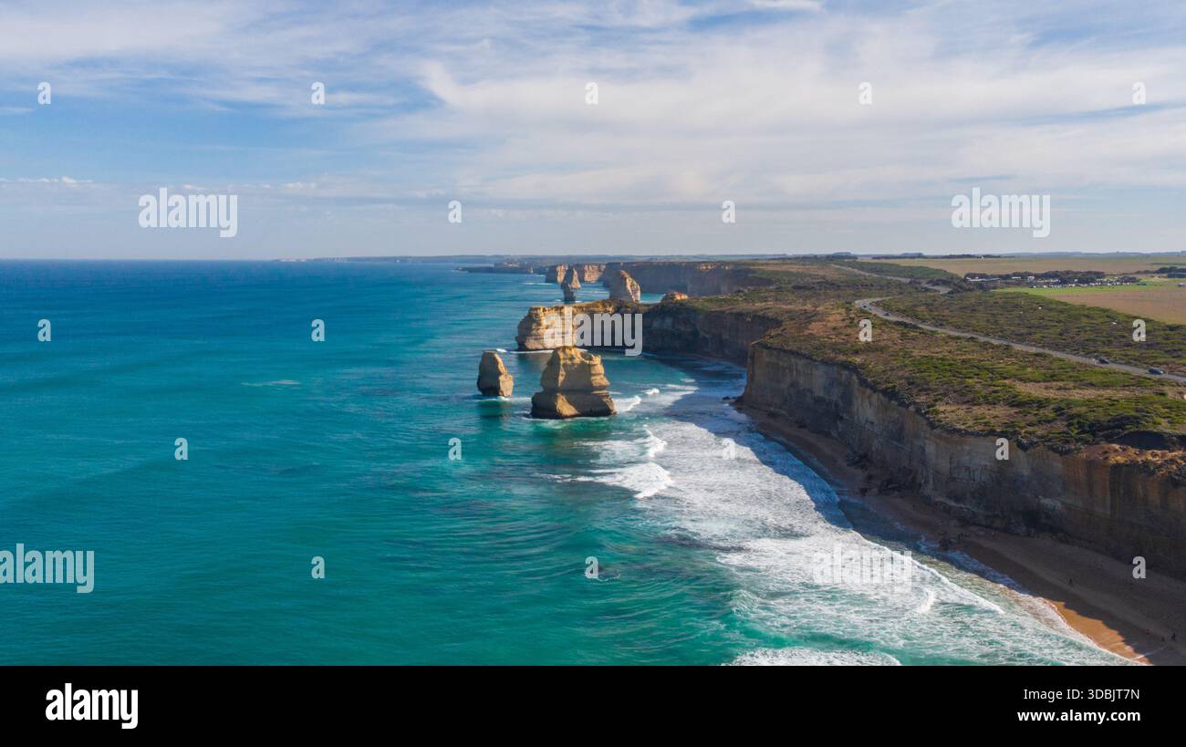 Aerial view of majestic limestone stacks meet the turquoise ocean under ...