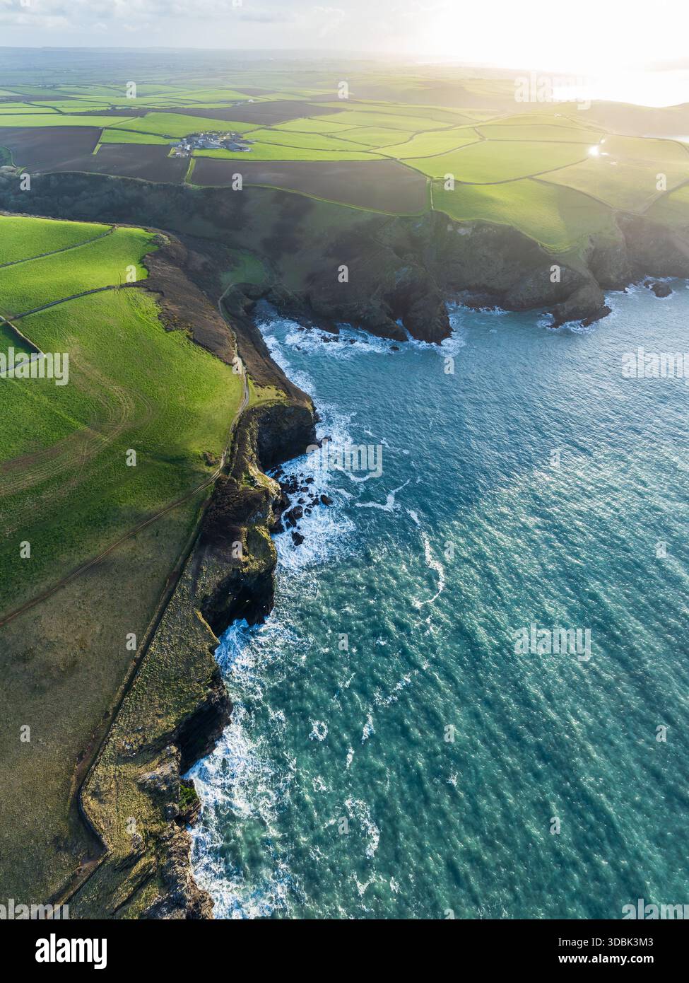 Aerial view of dramatic cliffs where verdant fields meet the restless ...