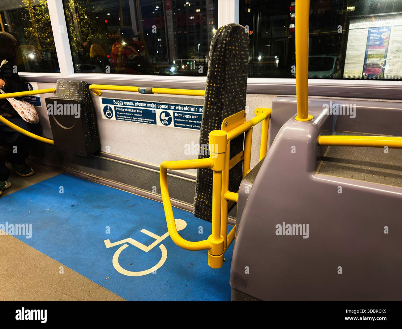 Inside a Manchester bus showing accessible seating and bright yellow ...