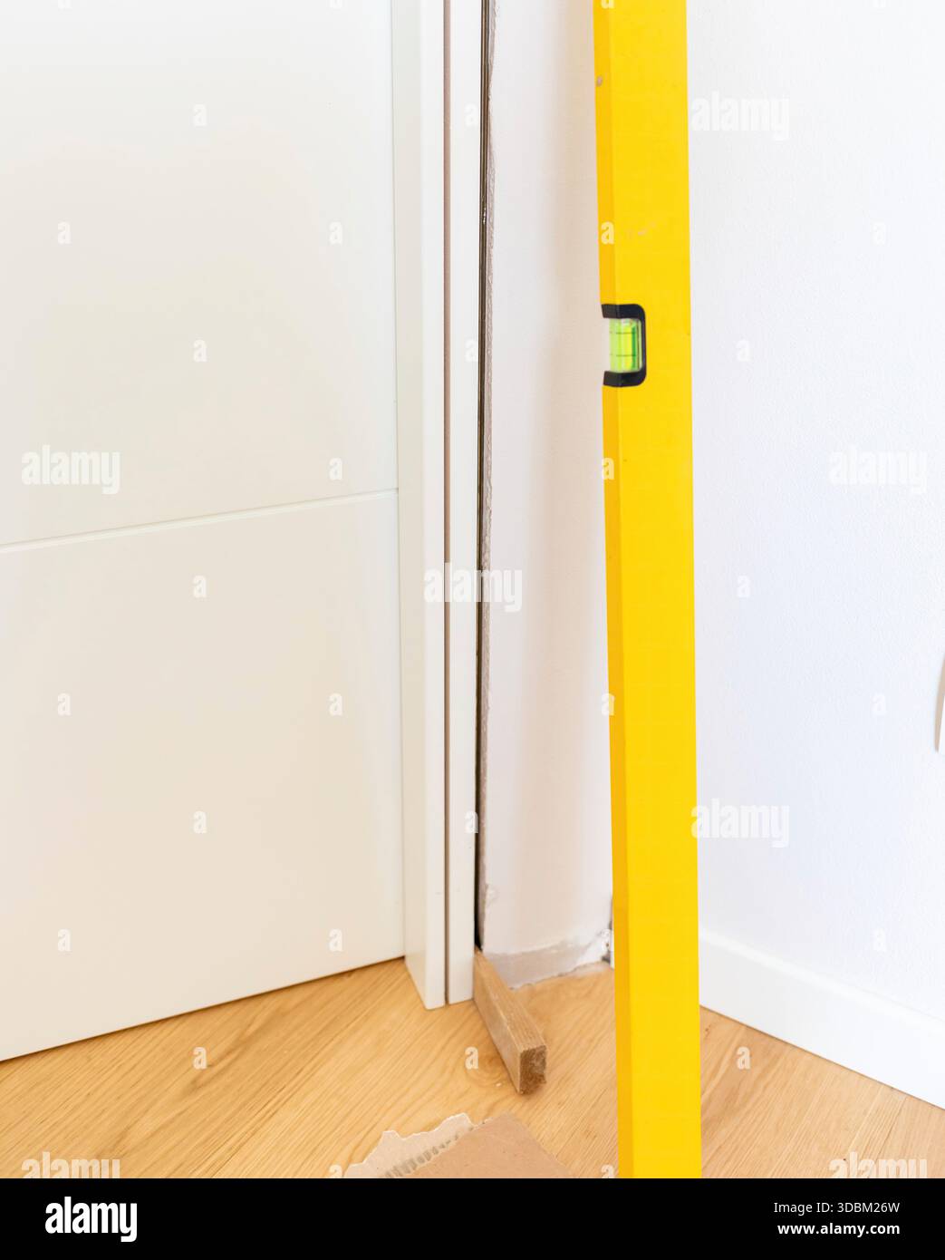 Yellow spirit level resting near door frame during installation hi-res ...