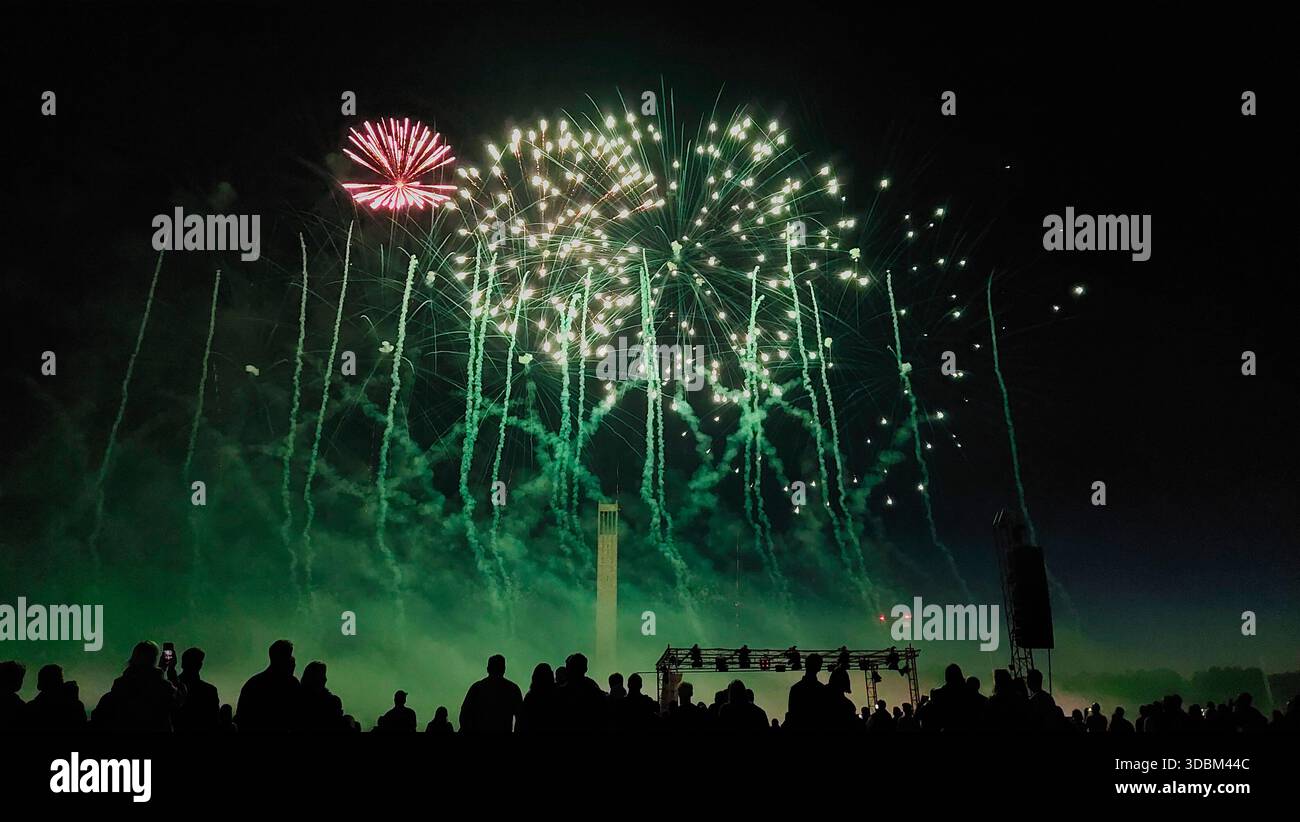 Fireworks in the dark night sky with lots of brightly lit rockets Stock ...