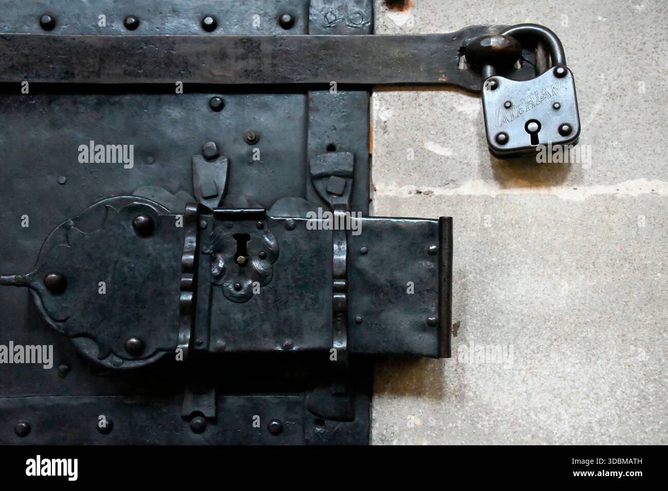 Medieval black door with lock and padlock Stock Photo - Alamy