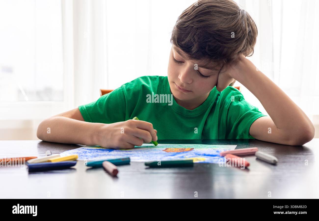 Focused Child in Green T-shirt Drawing with Crayons - Art Therapy for ...