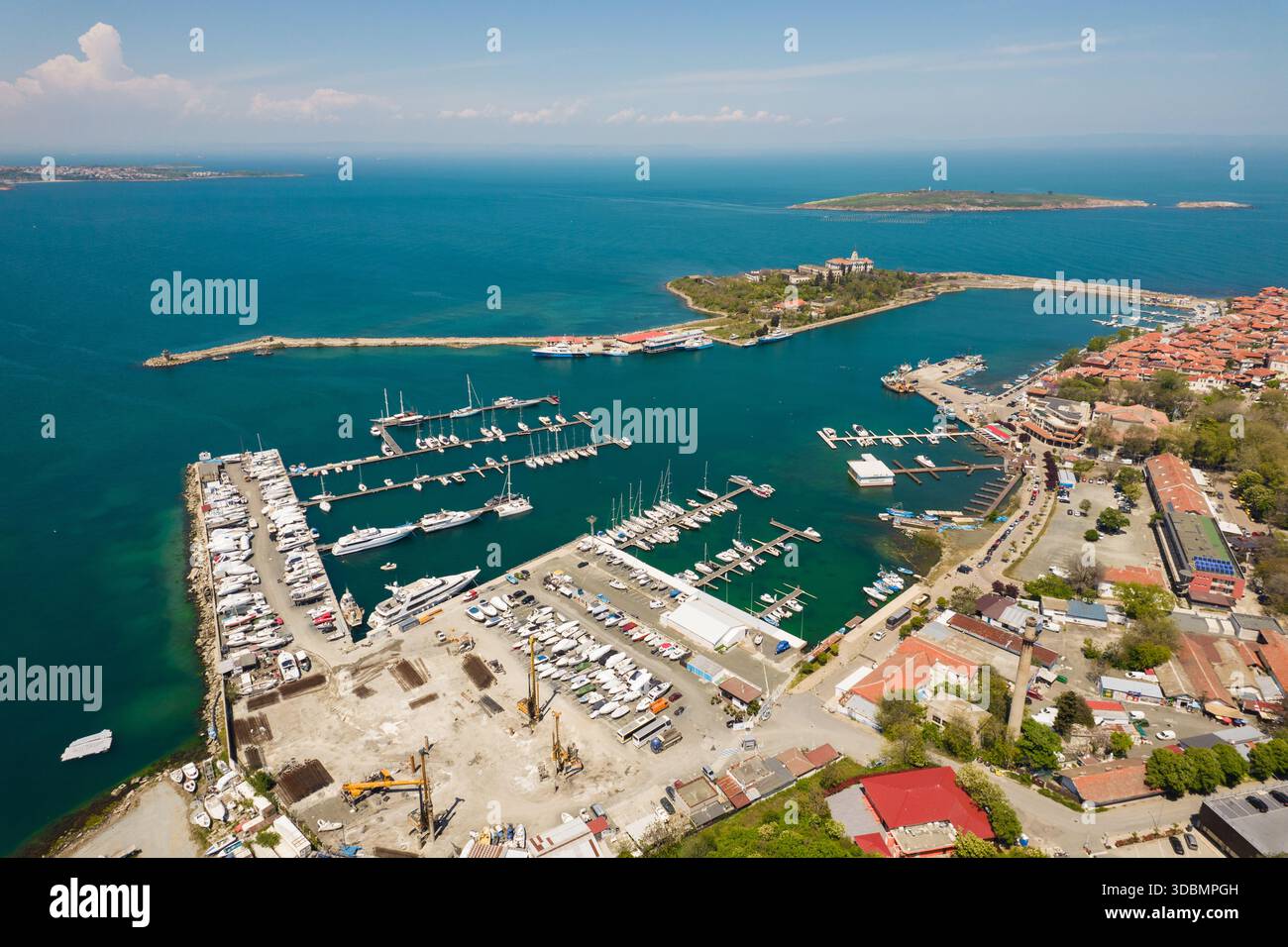 Aerial view of a vibrant harbor with boats docked next to the historic ...