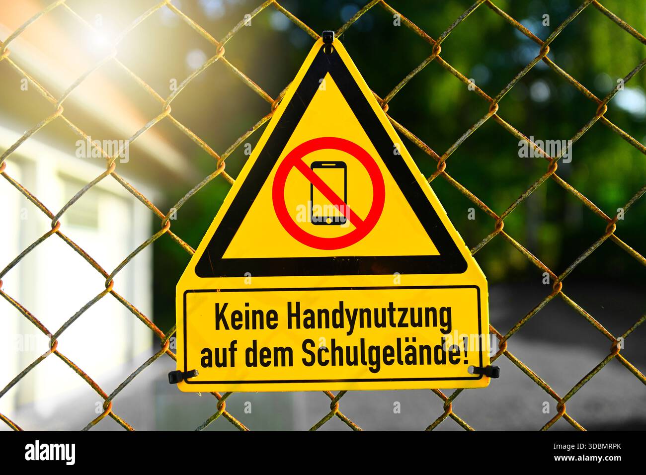 Sign with cell phone ban sign on a grille, symbolic photo cell phone ...