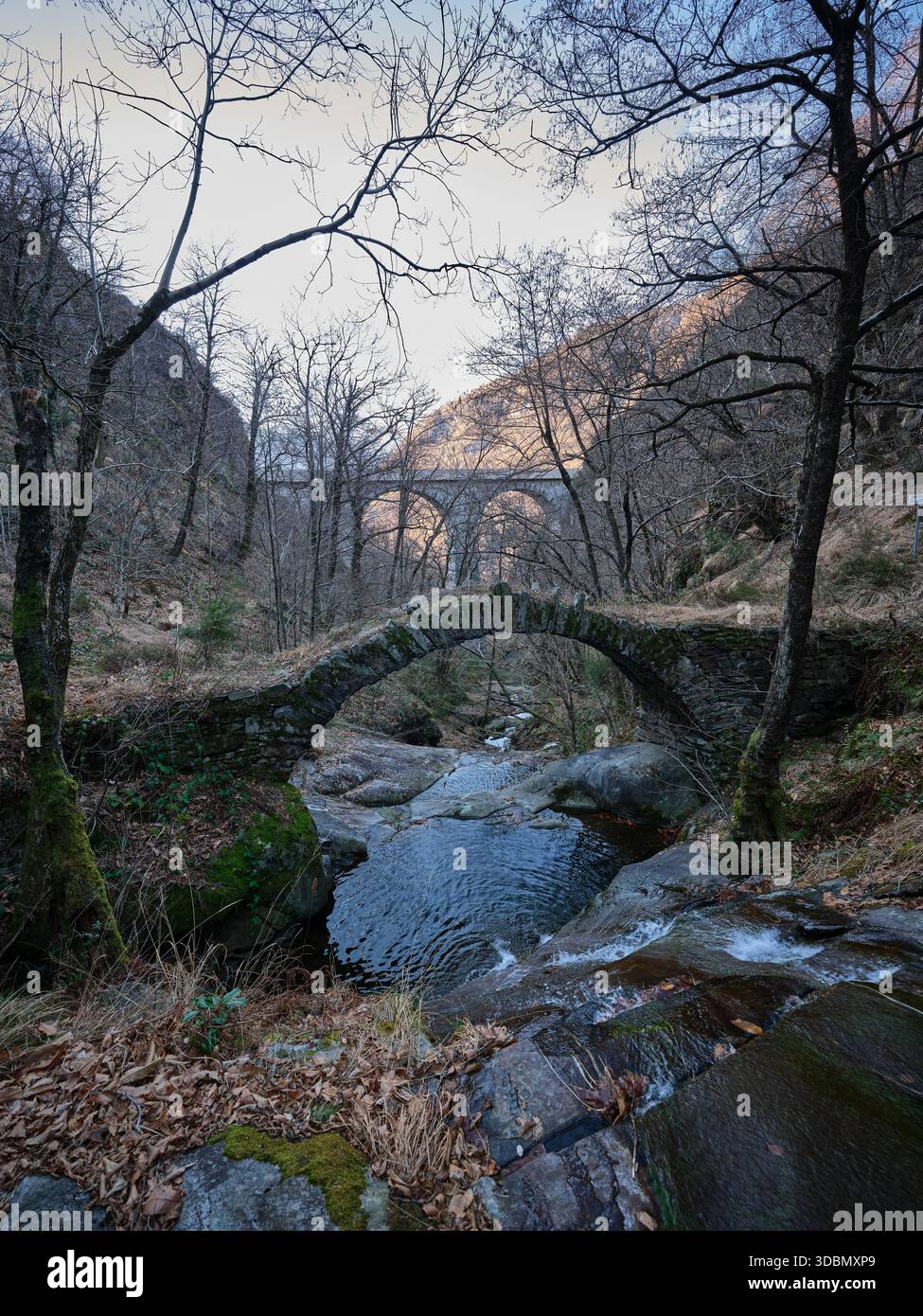 Historic dry stone arch bridge over the stream below cratolo, onsernone ...