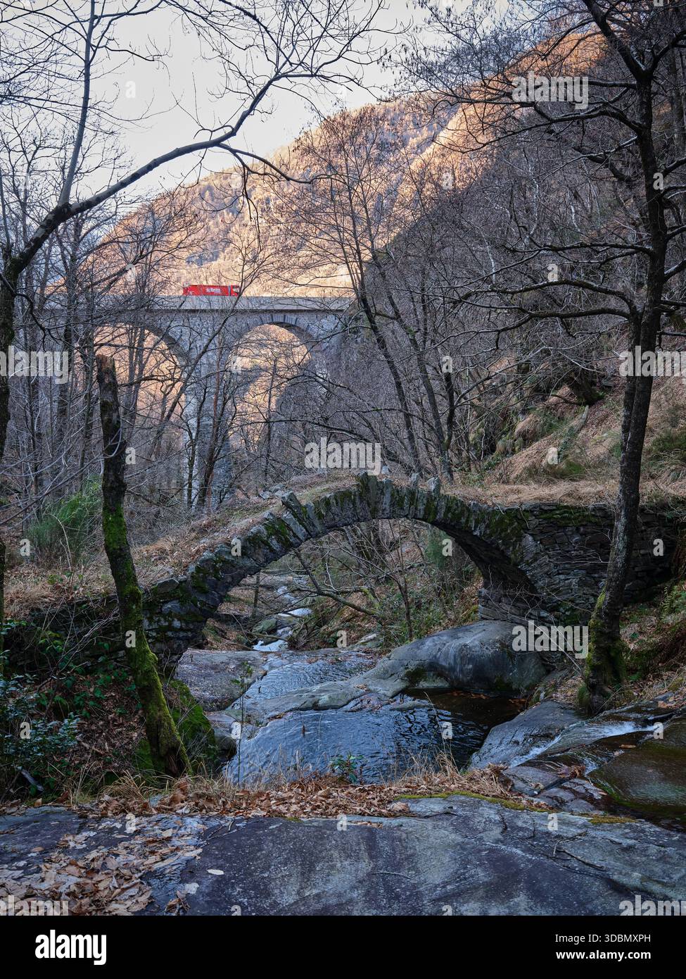 Historic dry stone arch bridge over the stream below cratolo, onsernone ...