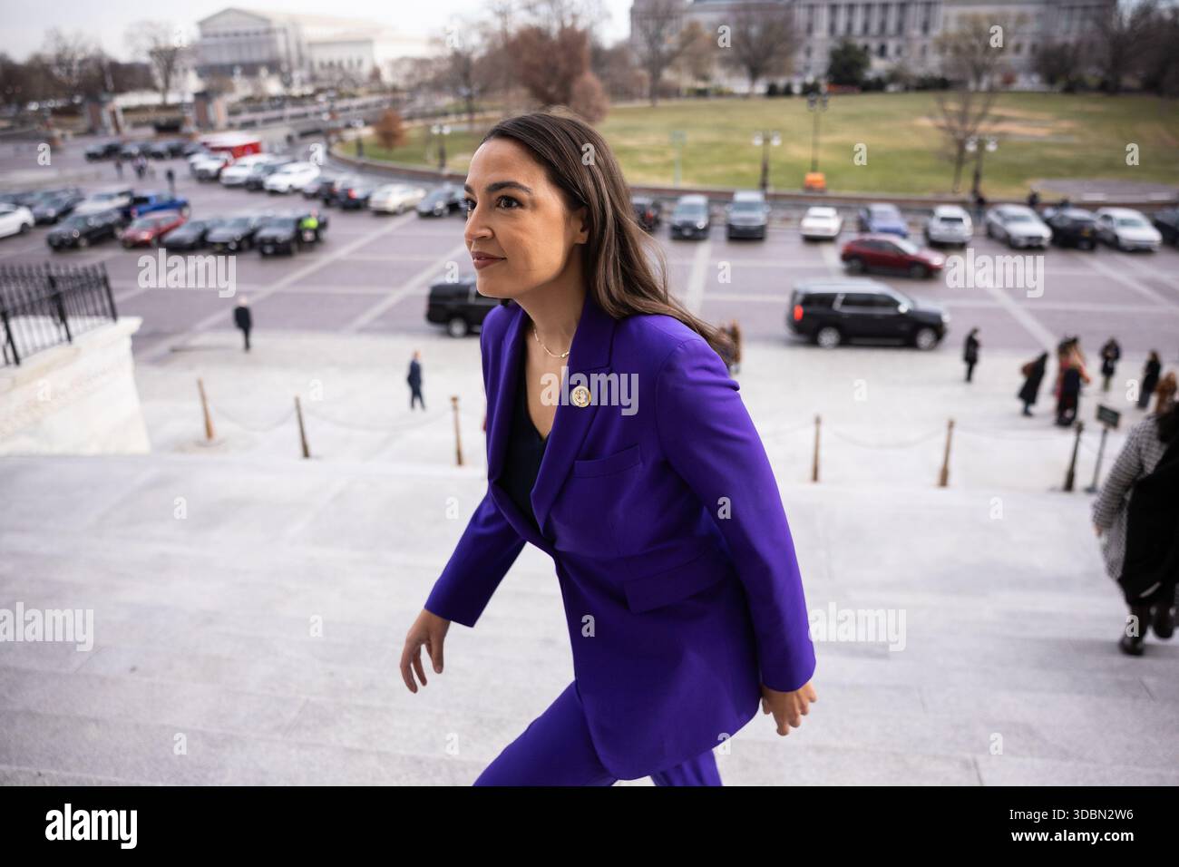 Rep. Alexandria Ocasio-Cortez (D-N.Y.) walks up the House steps after ...