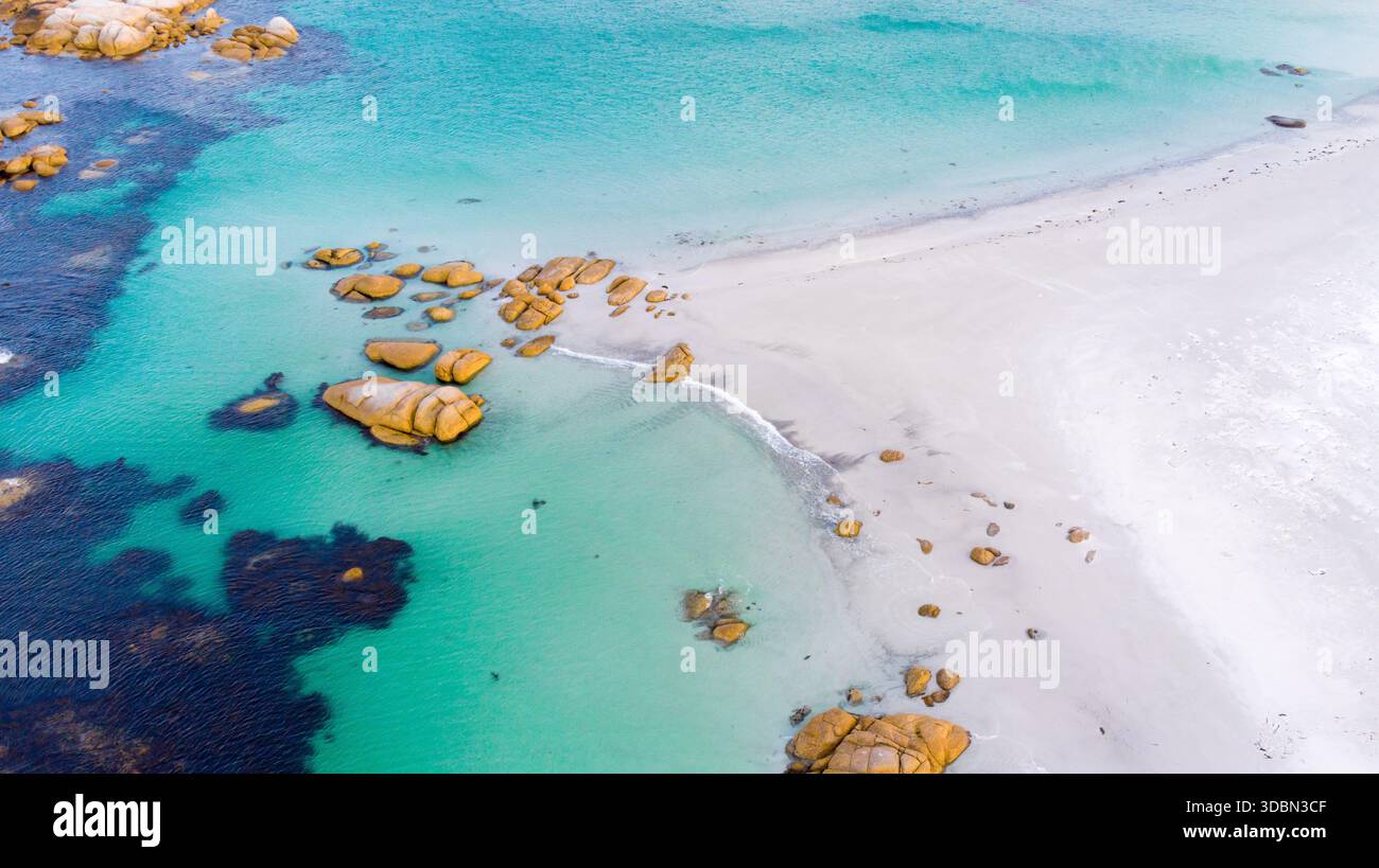 Aerial view of the turquoise water gently kissing the white sands ...