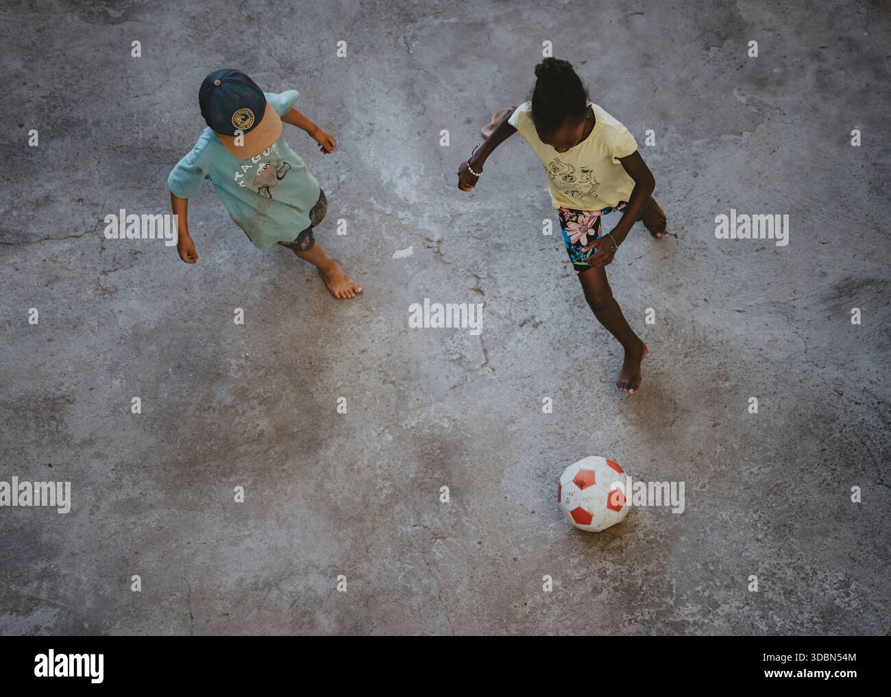 Children playing football in a courtyard Stock Photo - Alamy