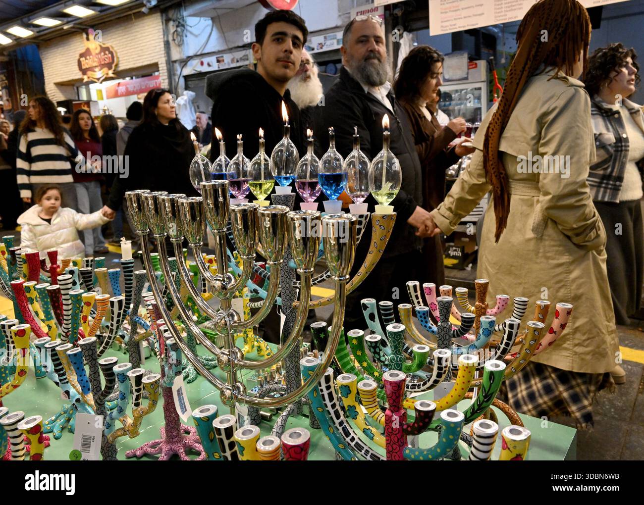 People pass a shop selling menorahs on the fourth night of the eight ...