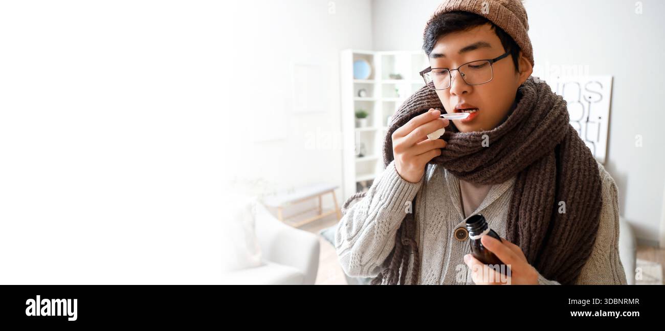 Ill Asian man taking cough syrup at home. Banner for design Stock Photo ...