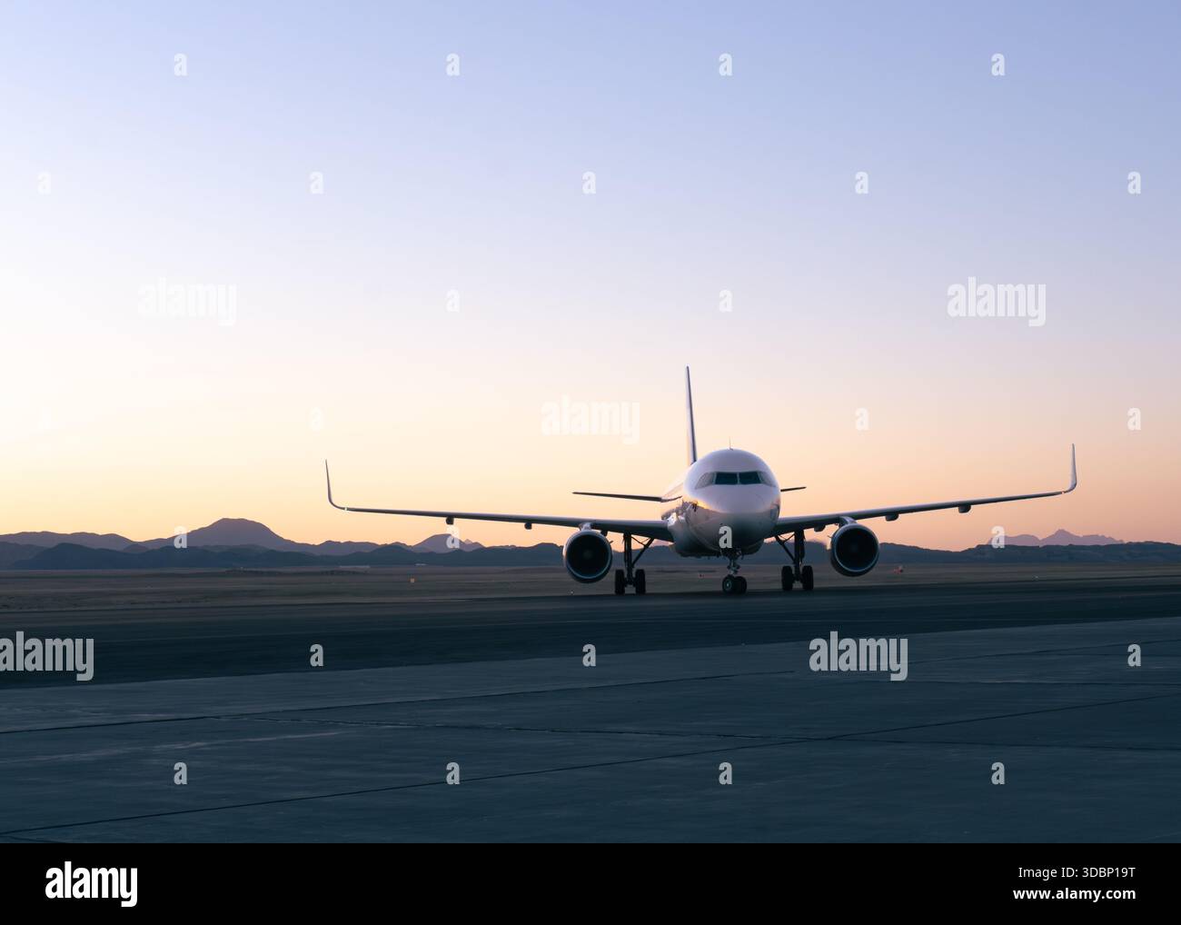Airbus jet facing camera at runway at dusk Stock Photo - Alamy