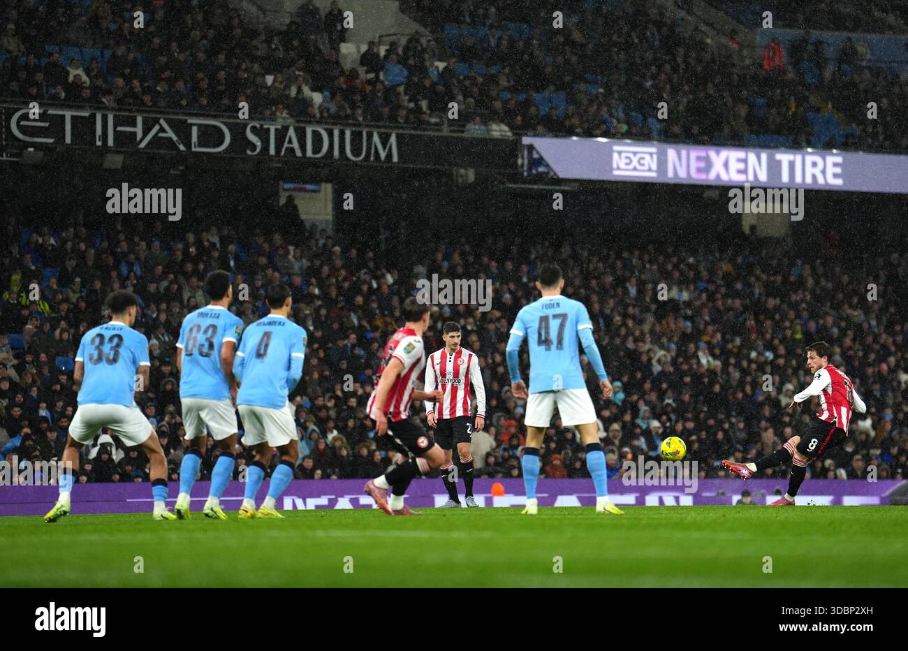 Brentford's Mathias Jensen (right) attempts a freekick during the ...