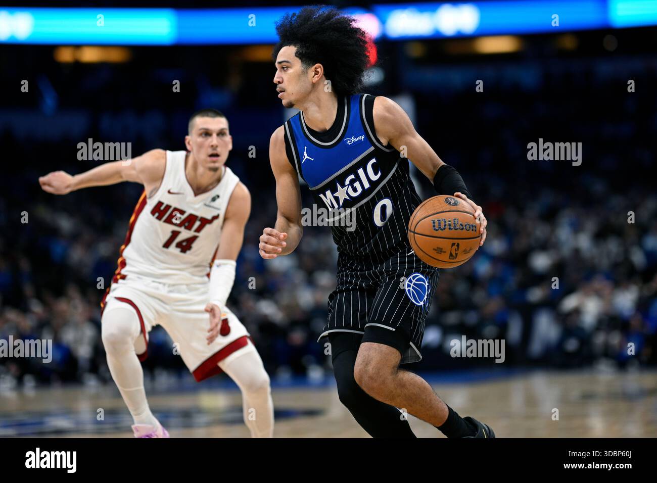 Orlando Magic guard Anthony Black (0) is defended by Miami Heat guard ...