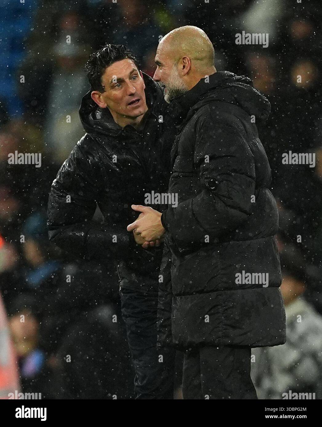 Brentford manager Keith Andrews (left) and Manchester City manager Pep ...