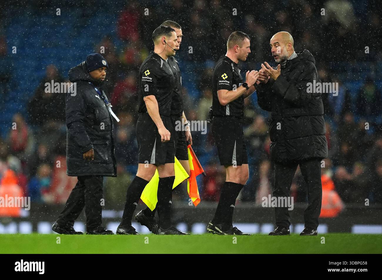 Manchester City manager Pep Guardiola (right) speaks with referee Sam ...