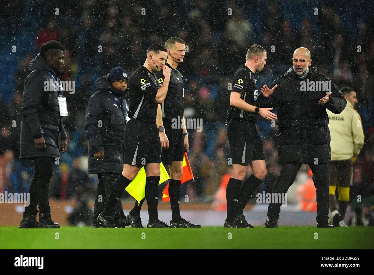 Manchester City manager Pep Guardiola (right) speaks with referee Sam ...