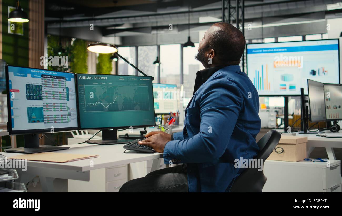Black businessman correcting his bad posture at the workstation ...