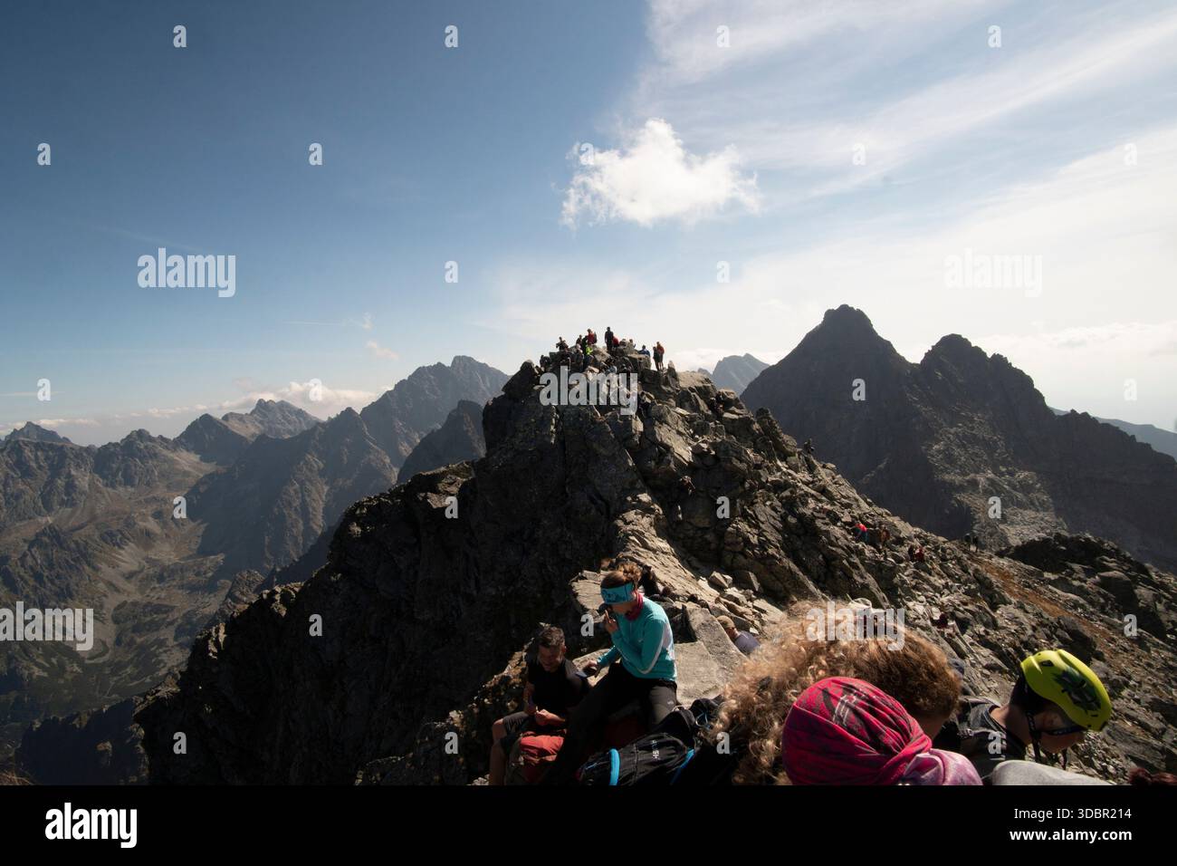 The summit of Rysy, Poland's highest mountain, with numerous hikers and ...