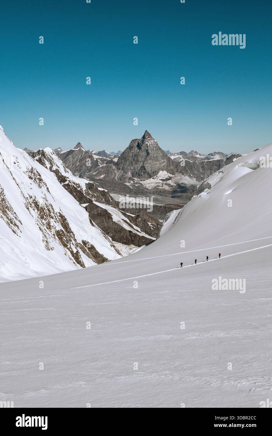 A rope team crosses the Monte Rosa glacier in the mountain massif of ...