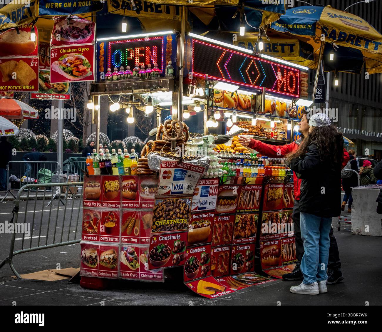 New York, NY – US – Dec 13, 2025 A vibrant NYC street food cart selling ...
