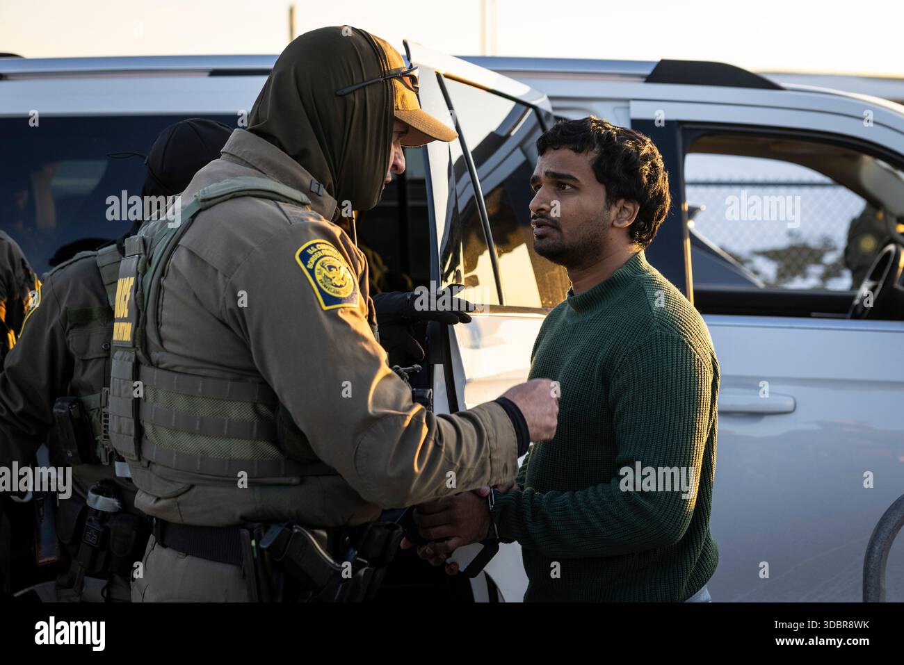 Federal immigration enforcement agents perform a checkpoint and detain ...