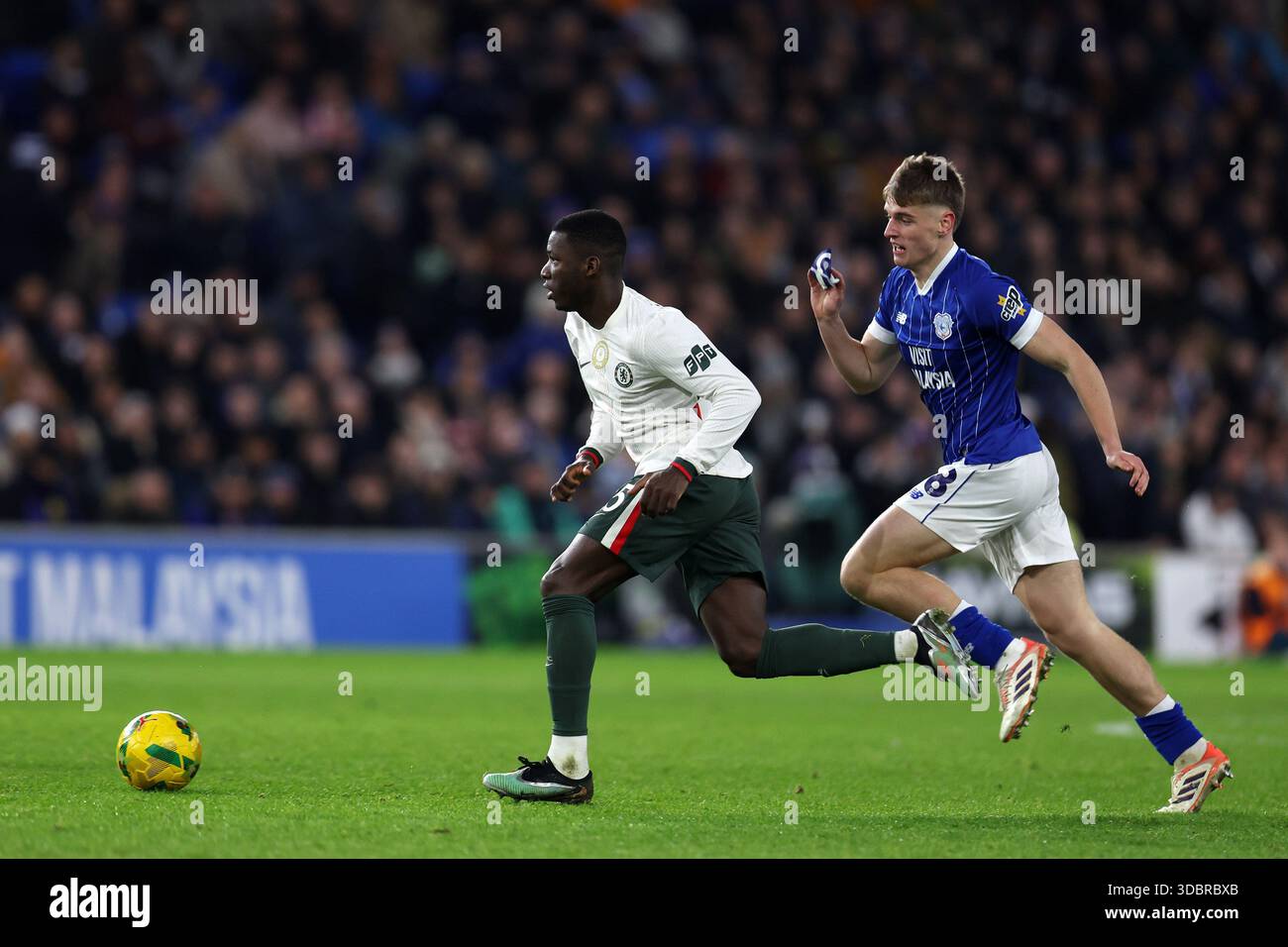 Moises Caicedo of Chelsea (l) breaks away from Dylan Lawlor of Cardiff City. Carabao Cup quarter ...