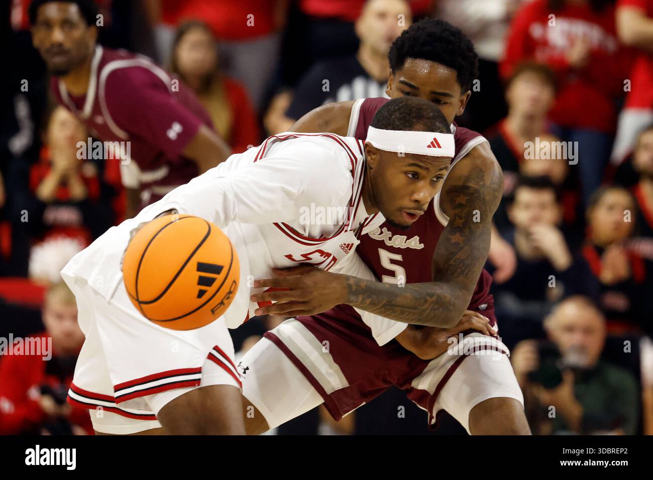 North Carolina State's Tre Holloman, left, drives the ball around TSU's ...