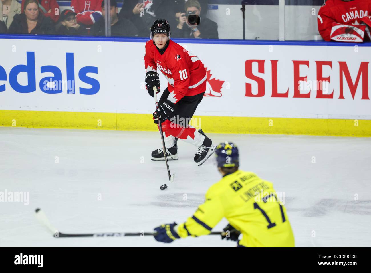 Canada's Cameron Reid (10) looks to pass around Sweden's Valter ...