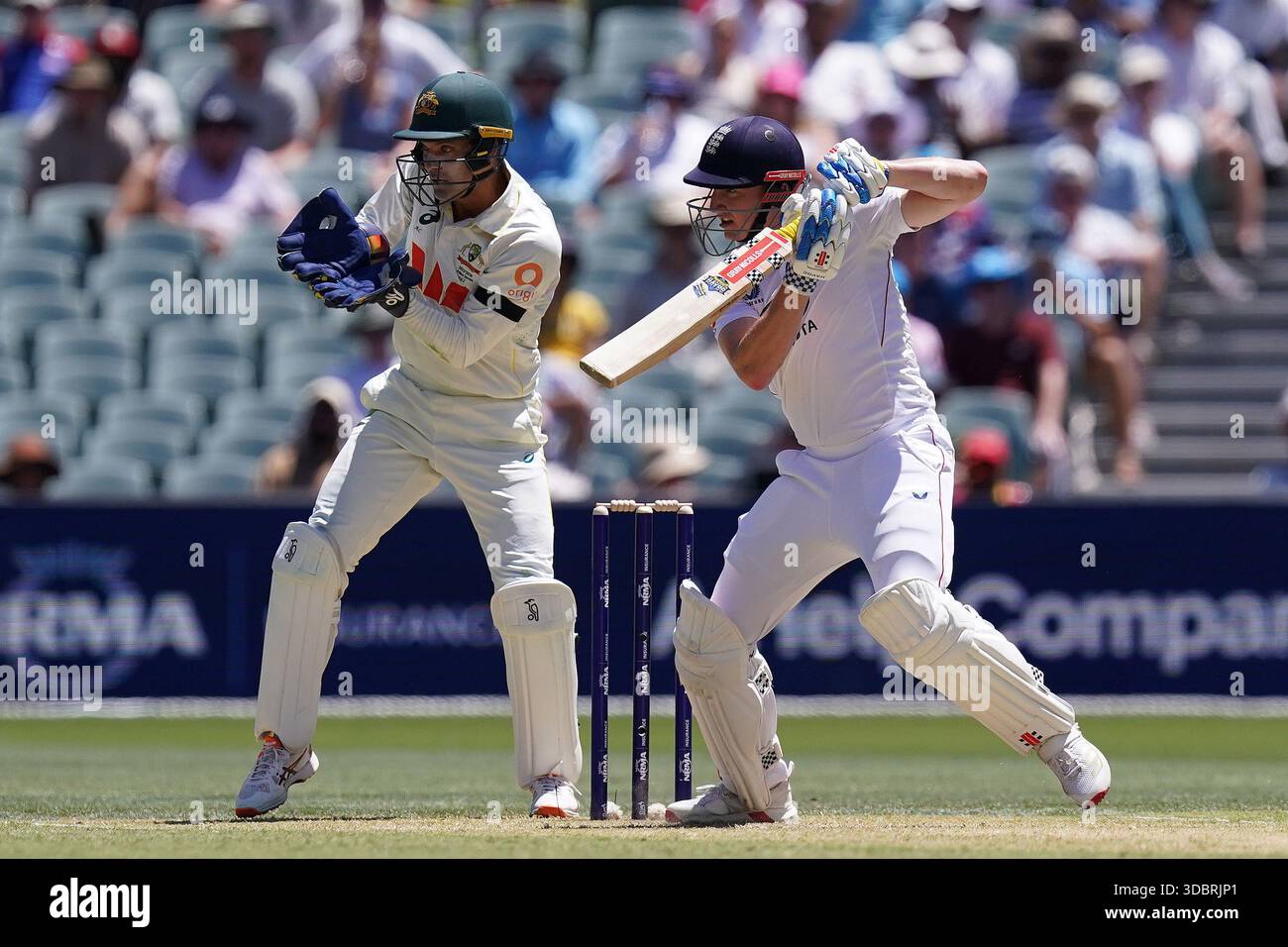 England’s Harry Brook bats while Australia's Alex Carey watches on from ...